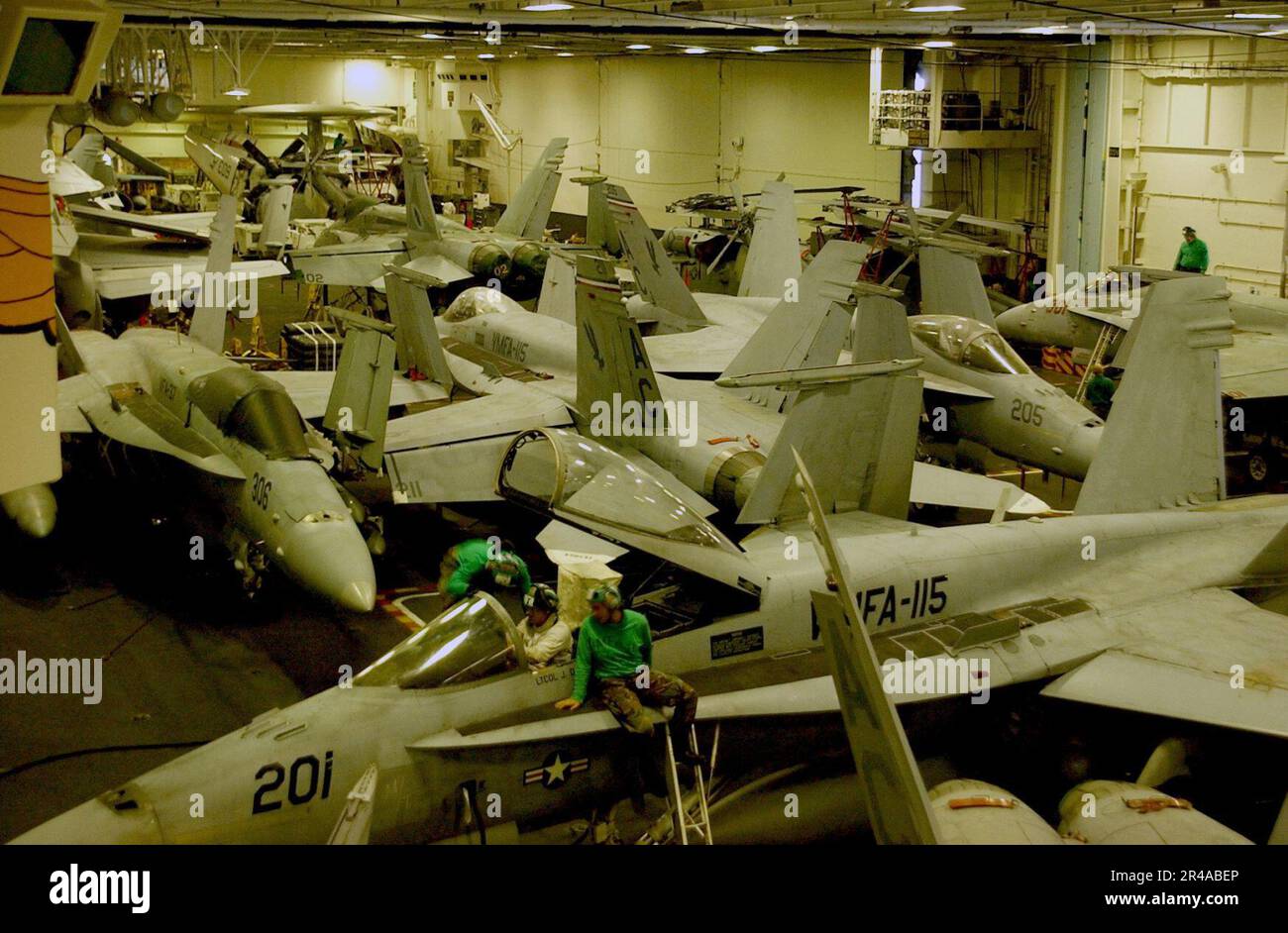 US Navy Squadron personnel perform maintenance on F-A-18 Hornets parked ...