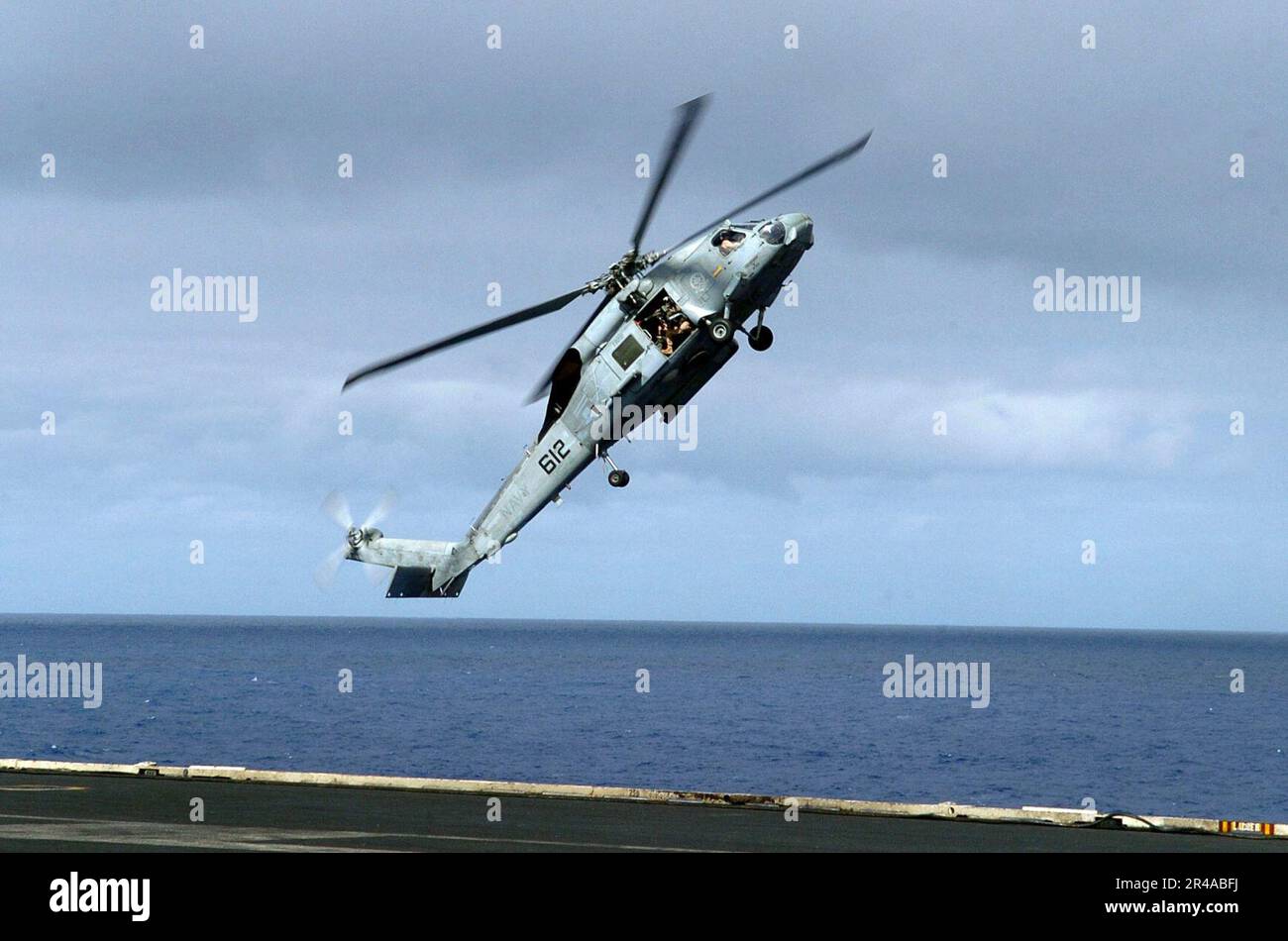 US Navy An SH-60F Seahawk performs a flare maneuver alongside the ...