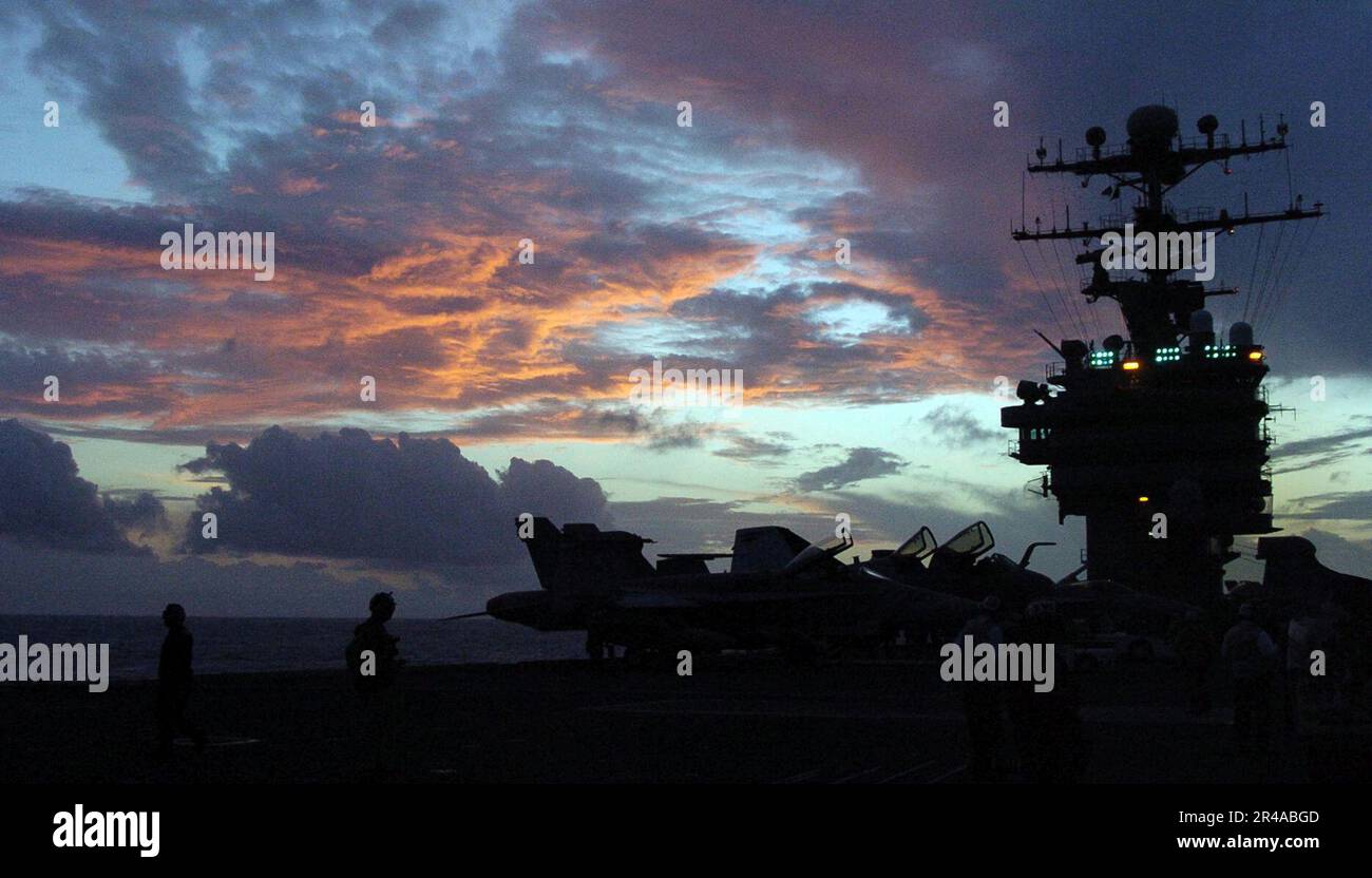 US Navy Flight deck personnel prepare for night flight operations as ...