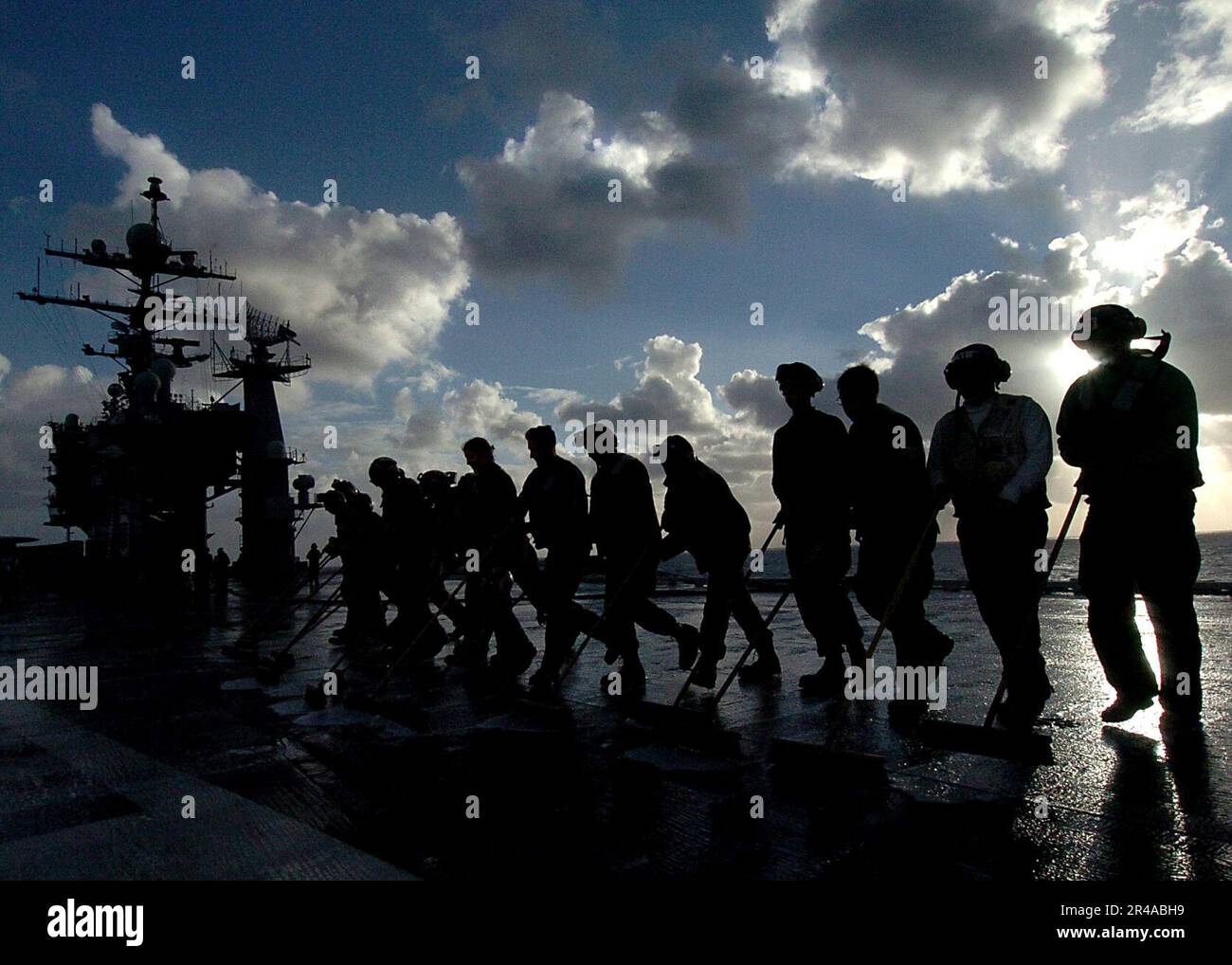 US Navy Sailors assigned to Air Department scrub the flight deck aboard ...