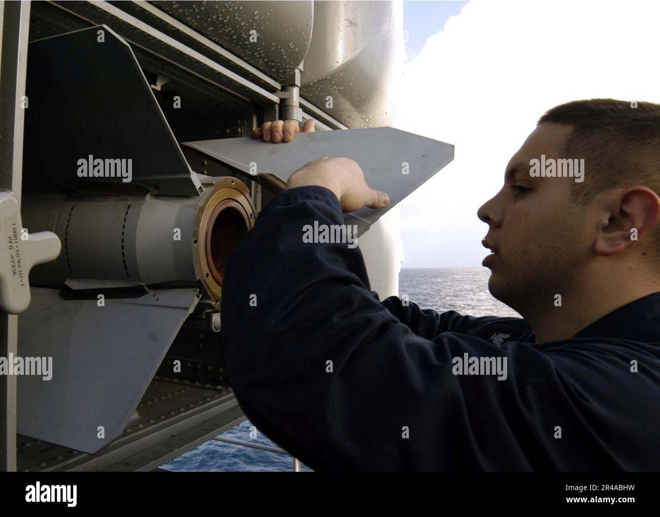 US Navy A Fire Controlman attaches the fin to a RIM-7 NATO Sea Sparrow ...