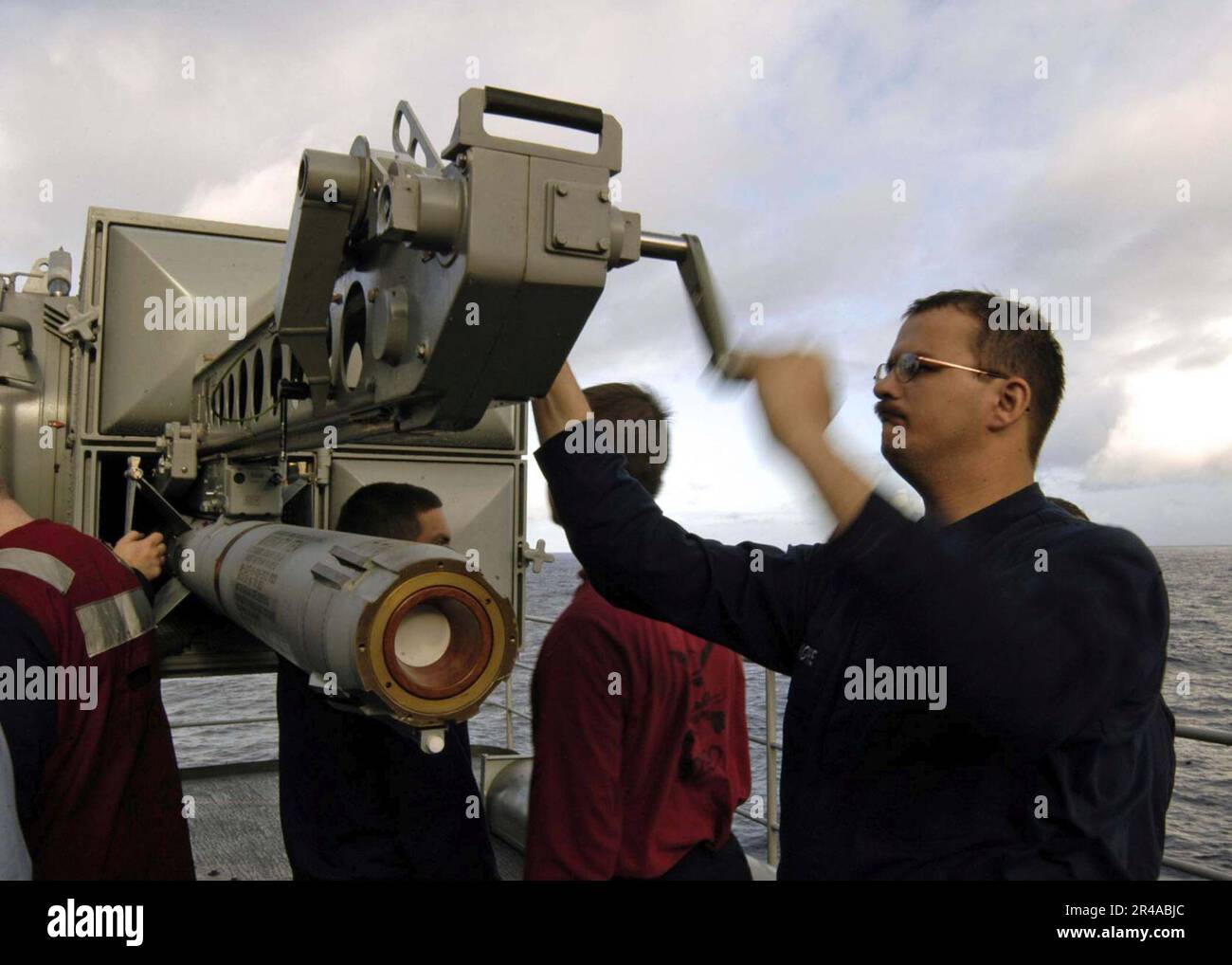 US Navy A Fire Controlman loads a RIM-7 NATO Sea Sparrow missile during ...