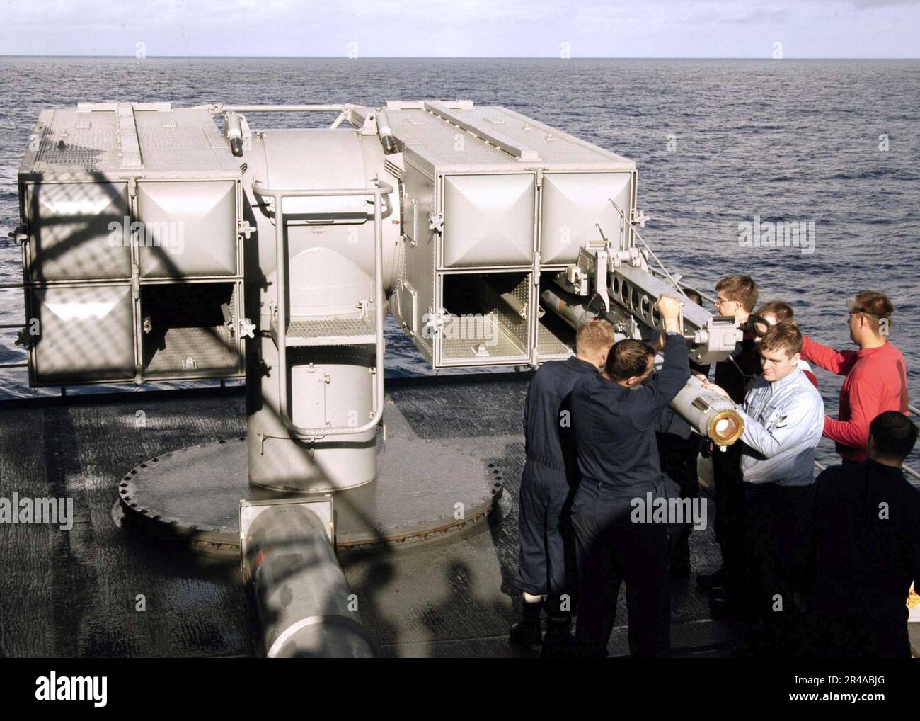 US Navy Fire Controlmen load a RIM-7 NATO Sea Sparrow missile during a ...