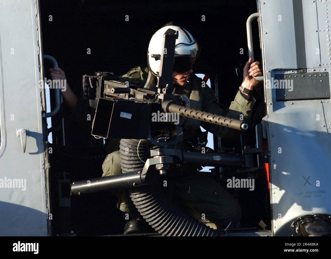 US Navy A door gunner aboard an SH-60 Seahawk prepares for landing ...