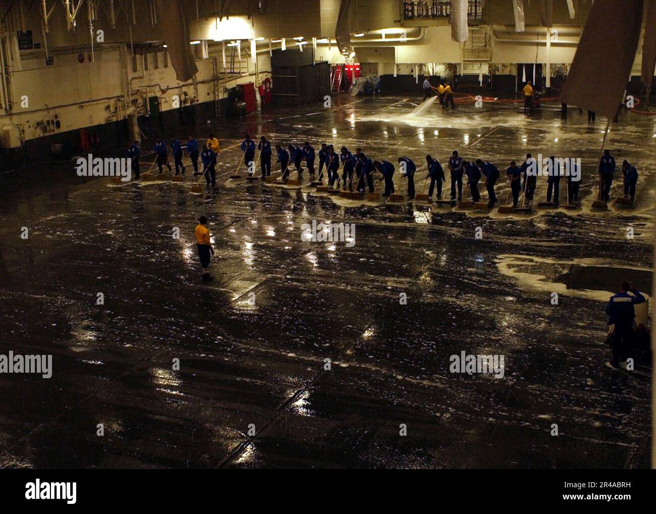 US Navy Air Department personnel scrub the hangar bay after testing the ...