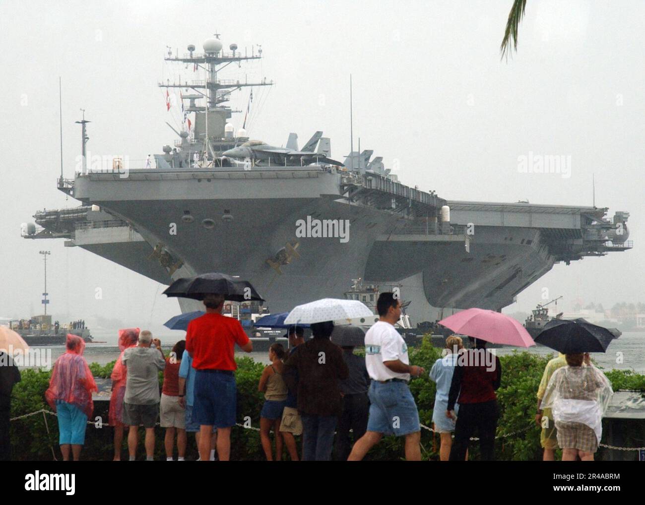 US Navy Visitors at the USS Arizona Memorial Visitor Center watch the ...