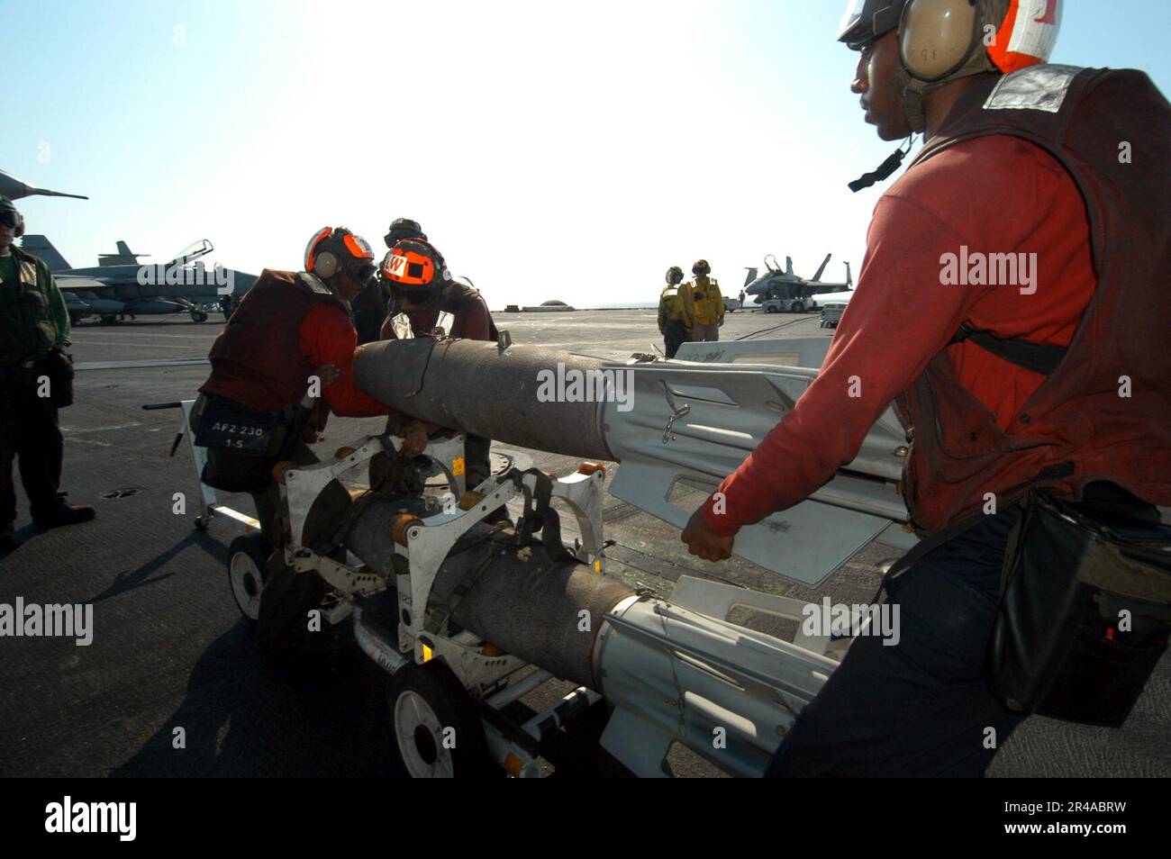 US Navy Aviation Ordnancemen move a skid of Mk-83 1,000 pound general ...