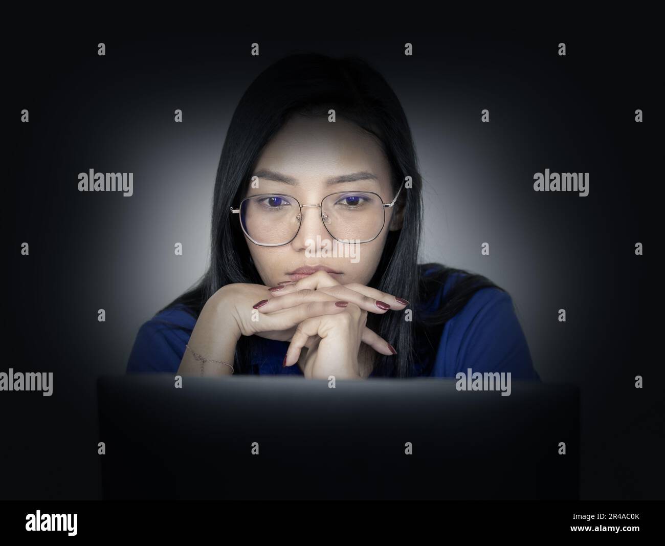 A young woman watch display of laptop at night Stock Photo - Alamy