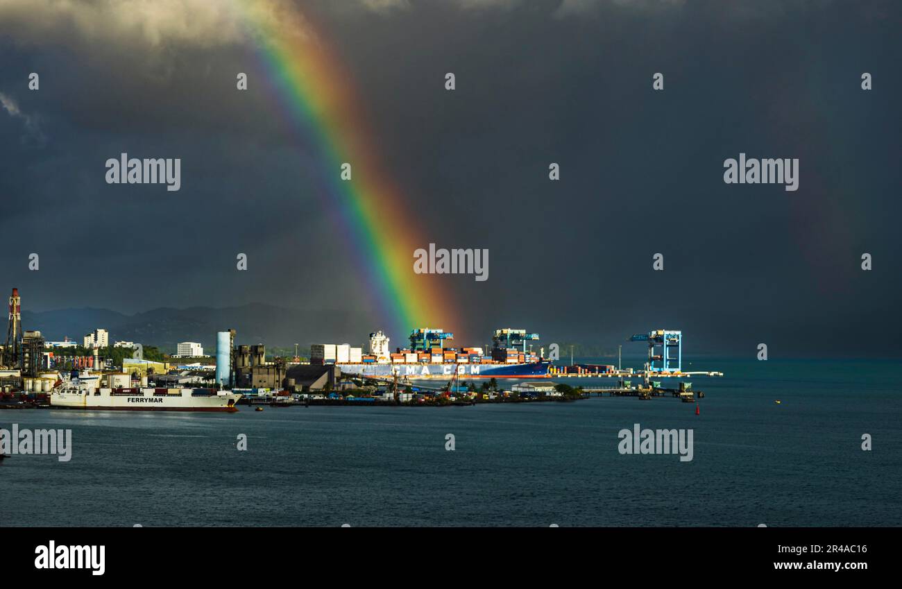 A vibrant rainbow spanning across the sky over the scenic shoreline of ...