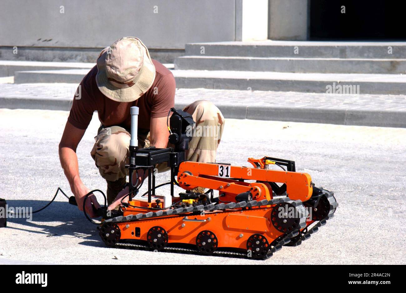 US Navy A Navy technician assigned to Explosive Ordnance Disposal ...