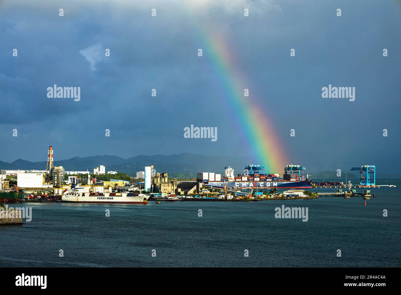 A vibrant rainbow spanning across the sky over the scenic shoreline of ...