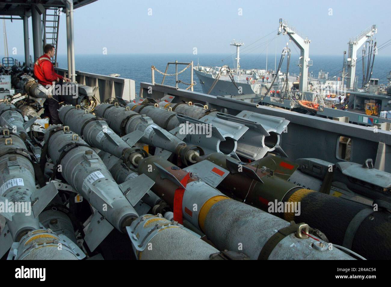 US Navy An Aviation Ordnanceman observes a replenishment at sea with ...