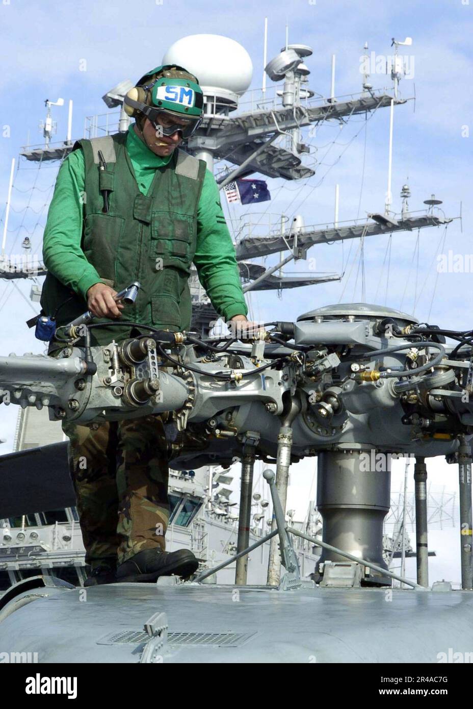 US Navy An Aviation Machinists Mate performs final maintenance prior to ...