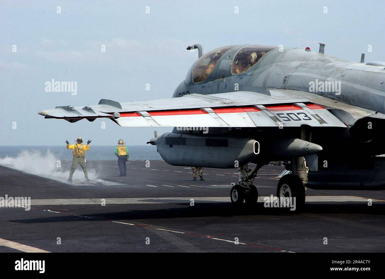US Navy A plane director uses hand signals to direct an EA-6B Prowler ...