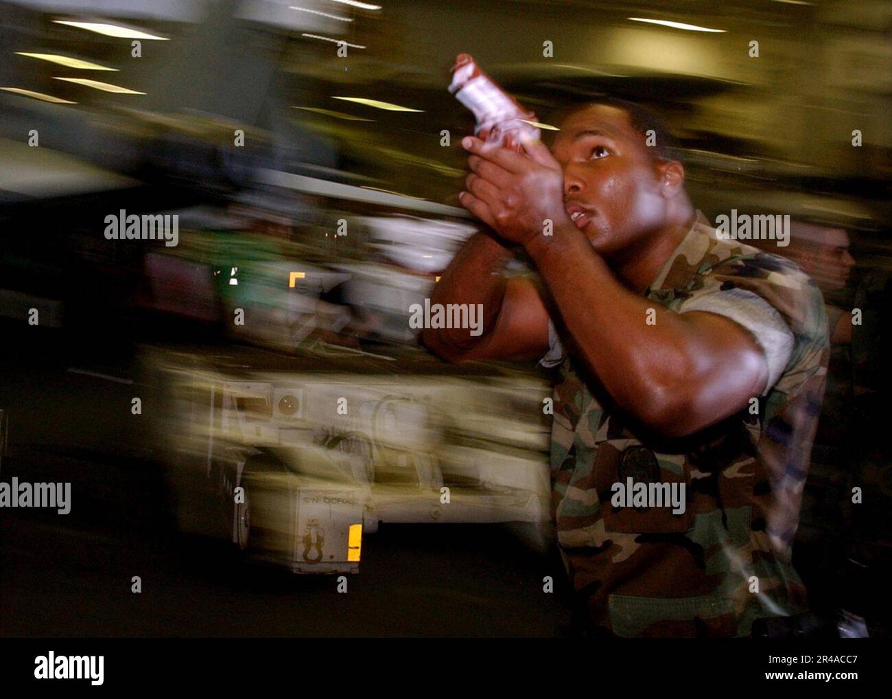 US Navy A Sailor performs tactical movements during a ships defense ...