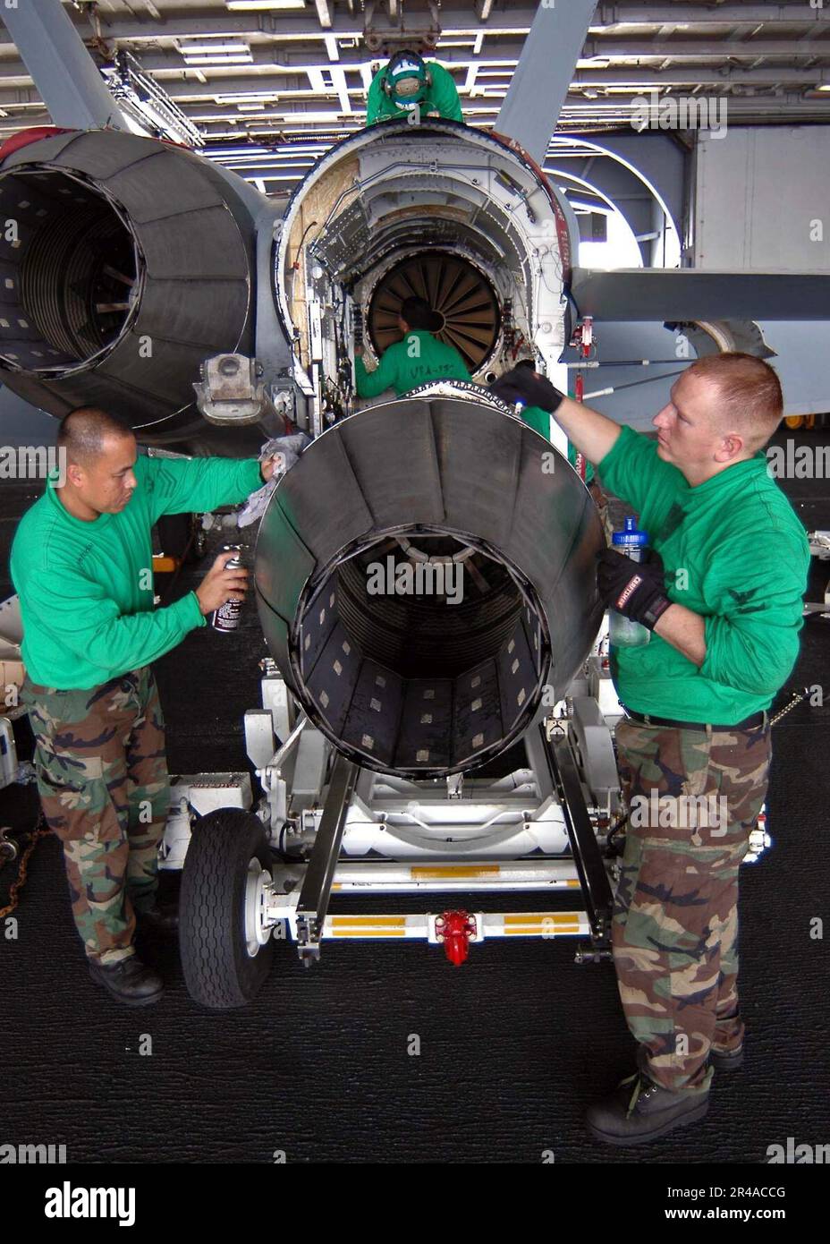 US Navy Sailors perform maintenance on an F-414-GE-400 jet engine used ...