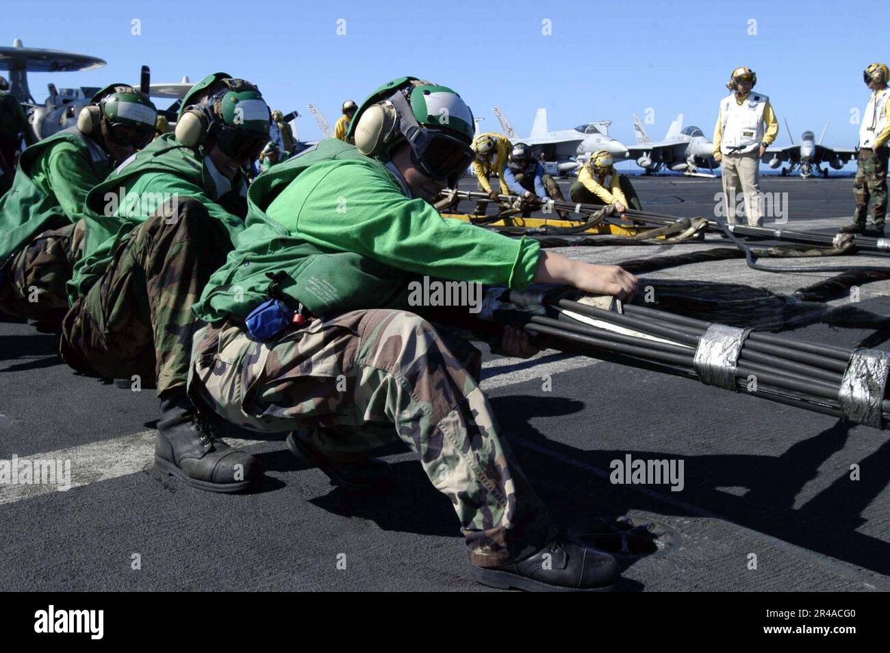 US Navy Crew members aboard the Nimitz-class aircraft carrier USS ...