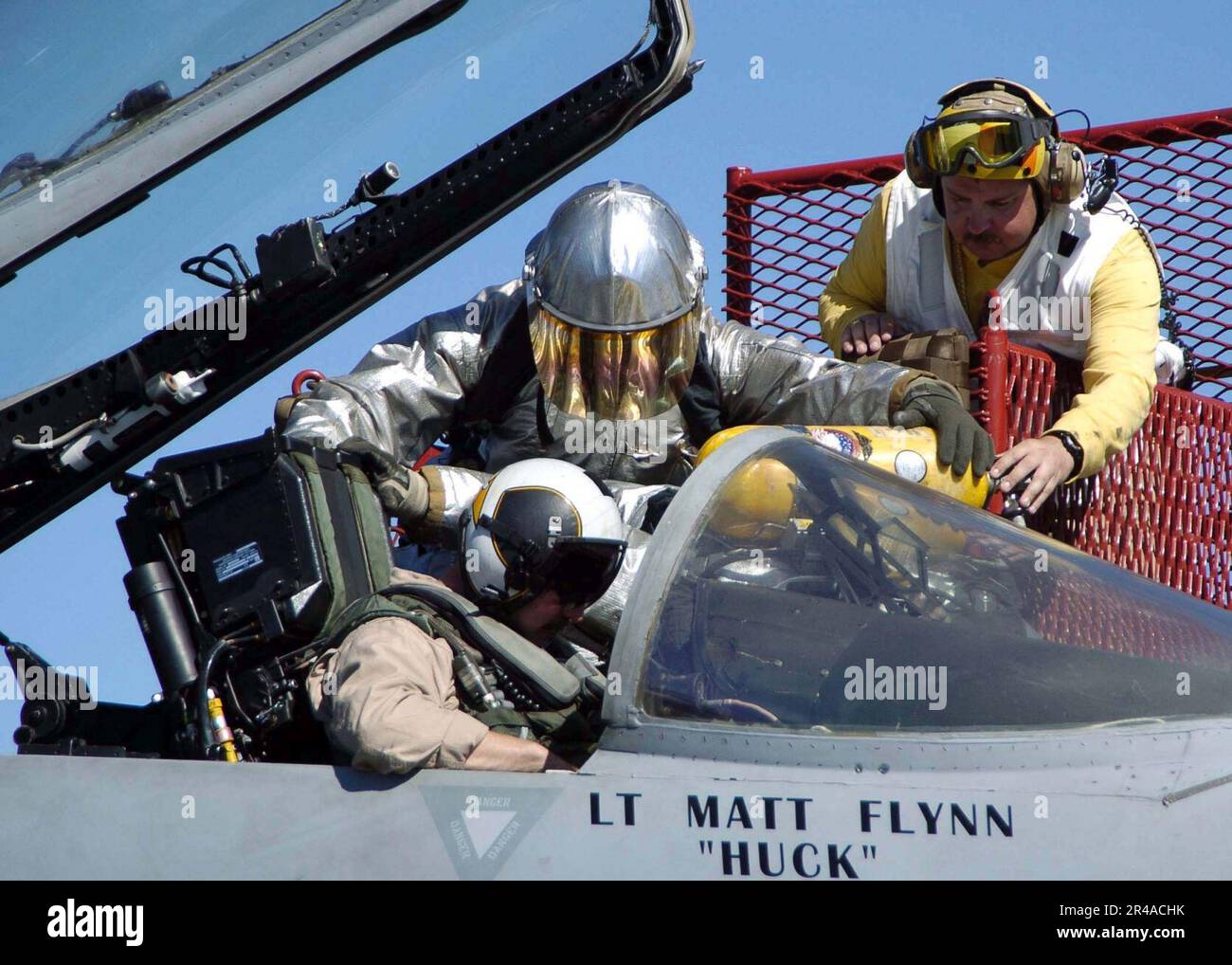 US Navy Firefighters remove the pilot of an F-A-18C Hornet during an ...