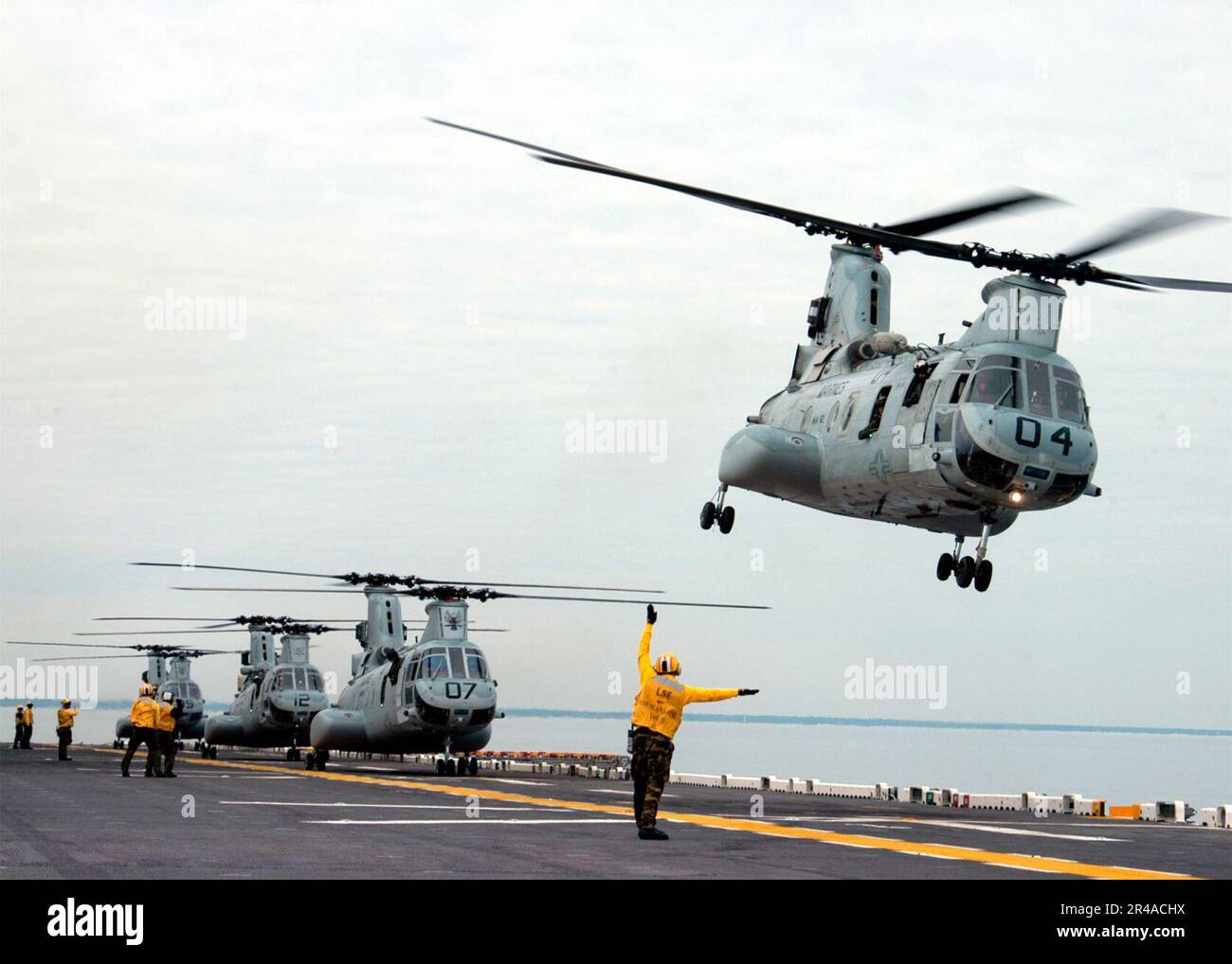 US Navy Flight deck personnel launch Marine CH-46 Sea Knight helicopters aboard USS Kearsarge ...