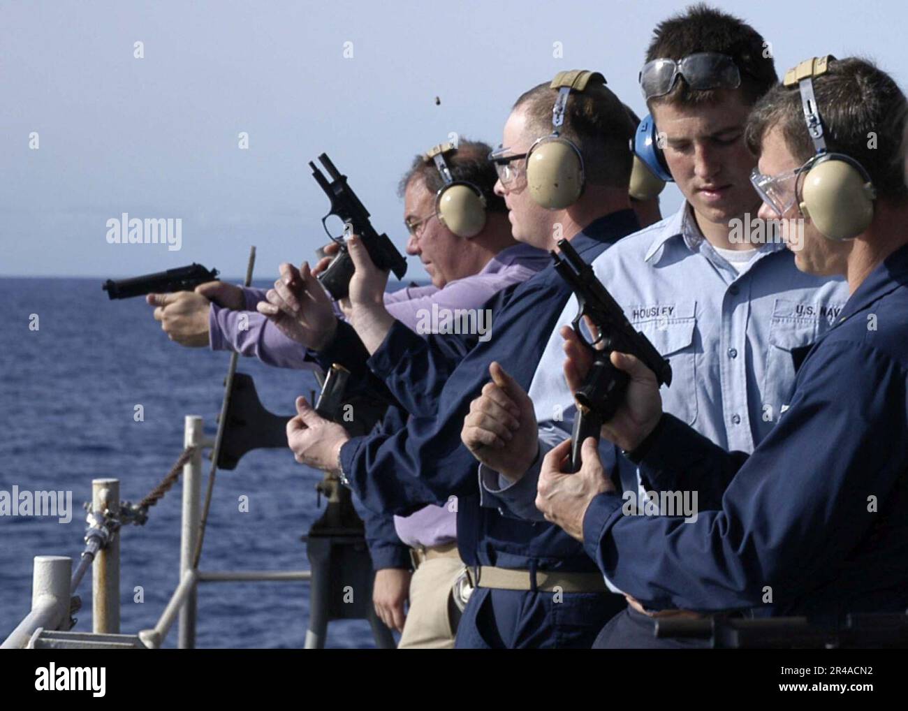 US Navy Crew members participate in a small arms qualifications on the ...