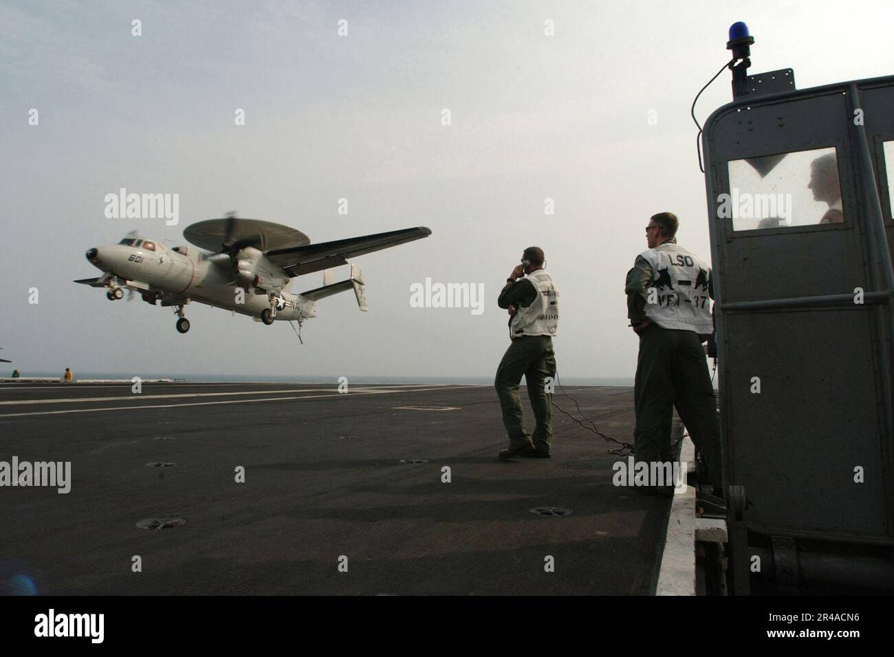 US Navy Landing Signal Officers (LSO) watch as an E-2C Hawkeye prepares ...