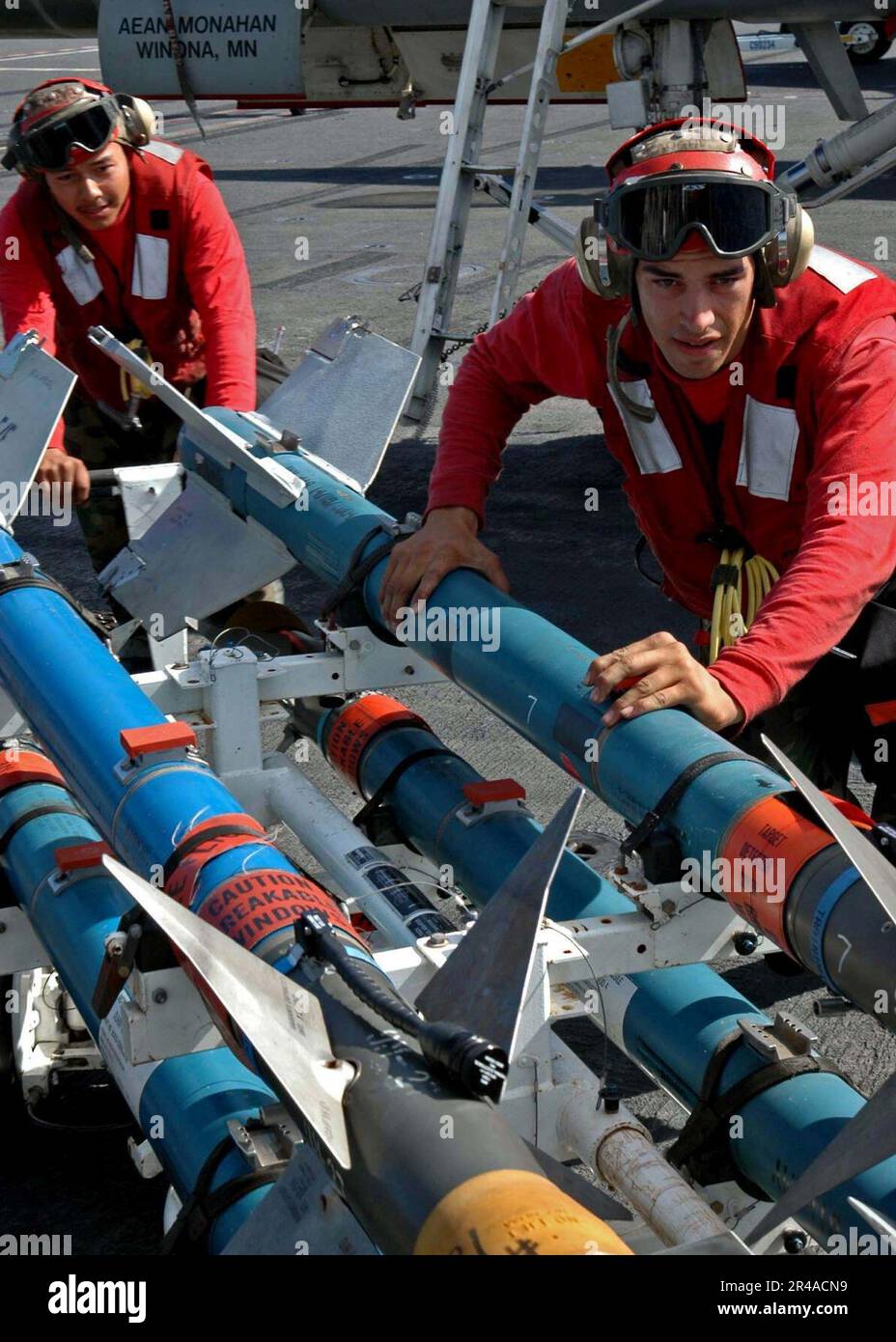 US Navy Aviation Ordnancemen move Air Training Missiles (ATM) across ...