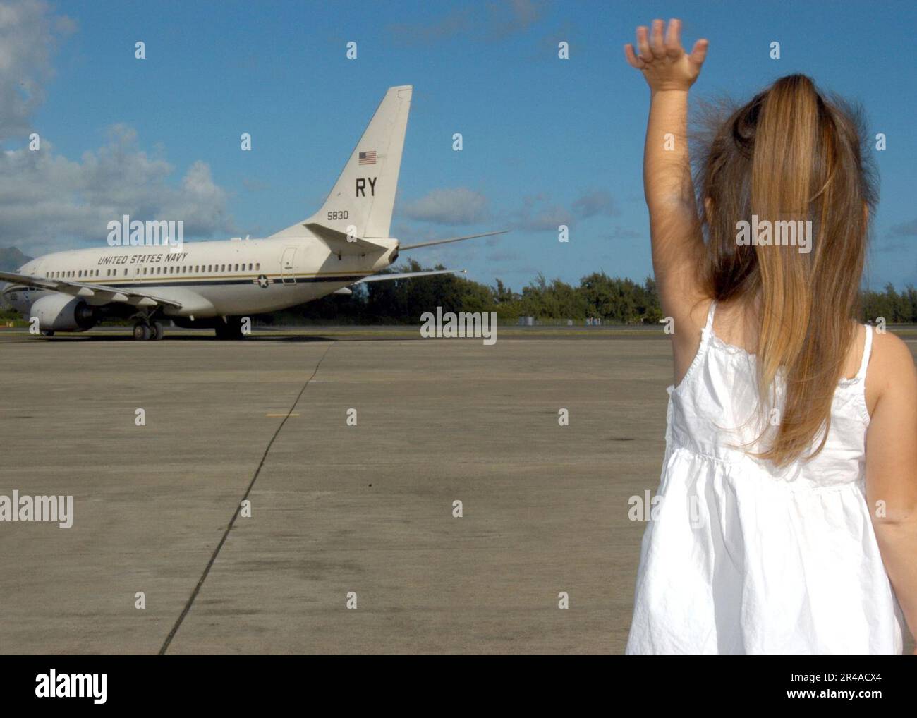 US Navy A family member of a Sailor waves goodbye to her father as he ...