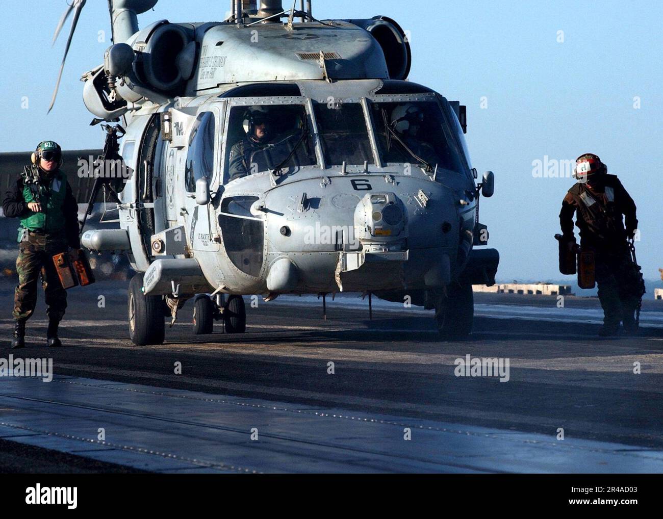 US Navy Personnel remove the wheel chocks of an HH-60H Seahawk Stock ...