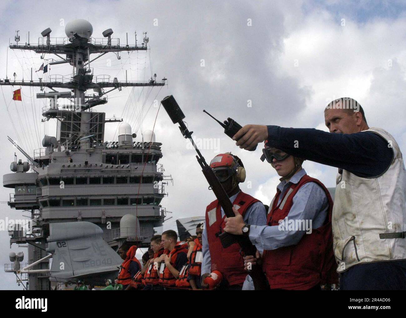 US Navy Torpedoman's Mate John N. Hansen receives instruction on where ...