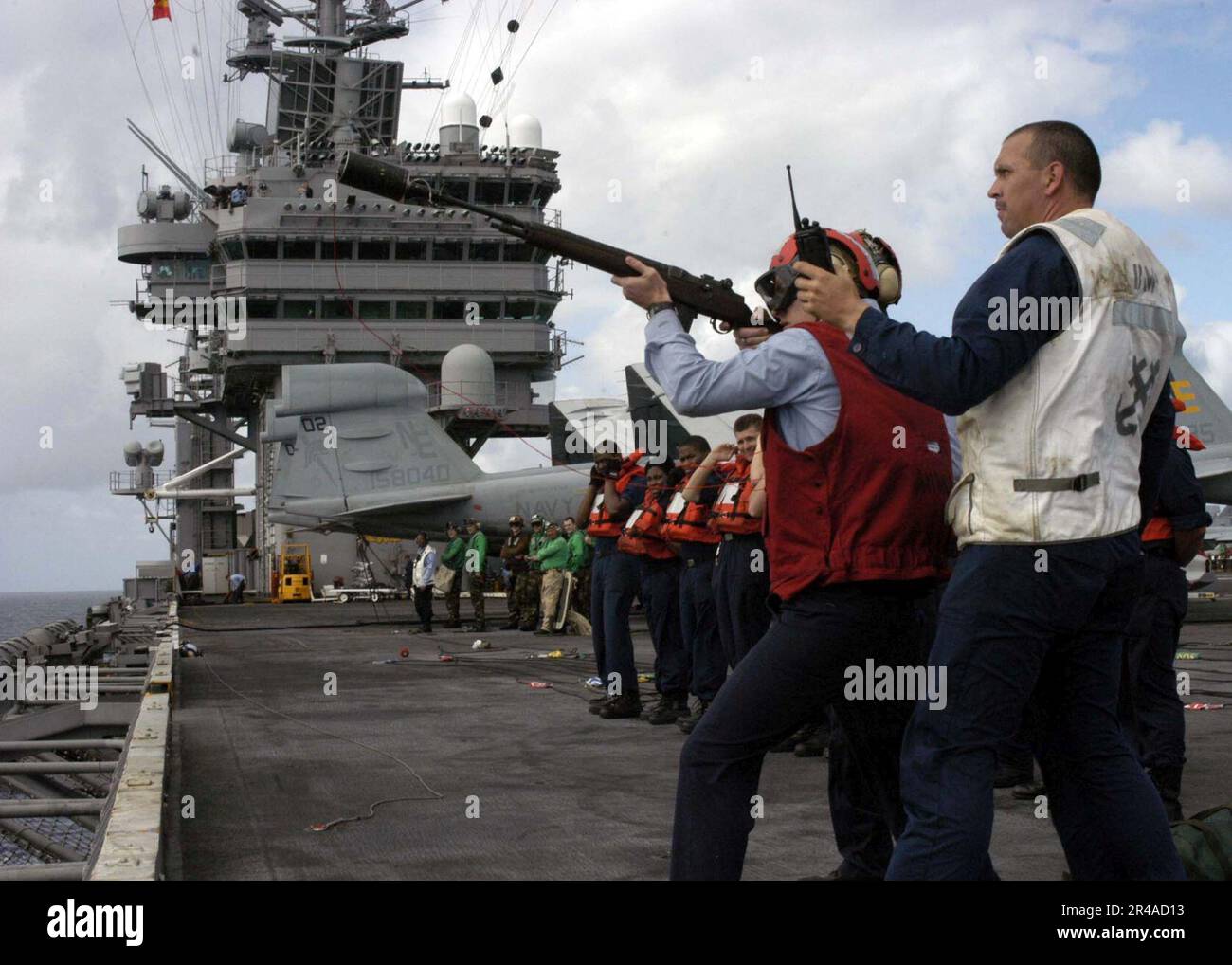 US Navy Torpedoman's Mate John N. Hansen prepares to fire a shot line ...