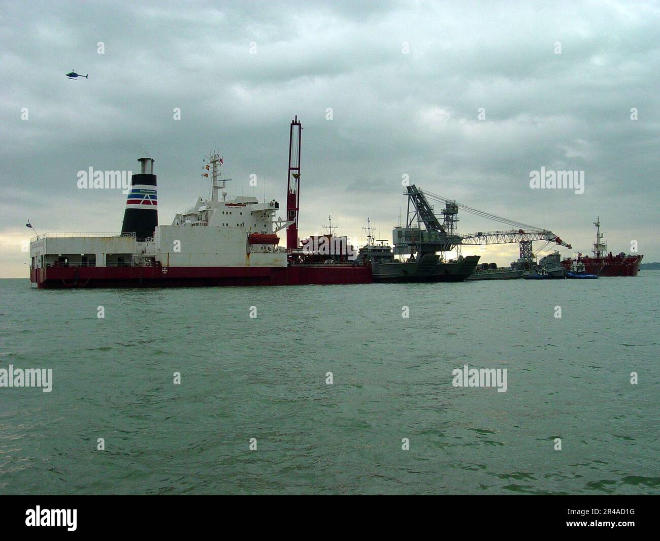 US Navy U.S. Army watercraft are floated onto the submerged cargo deck ...