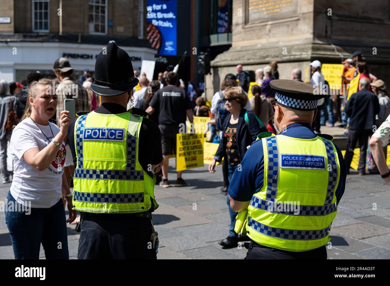Three police officers stand in a crowded area during protests Stock ...