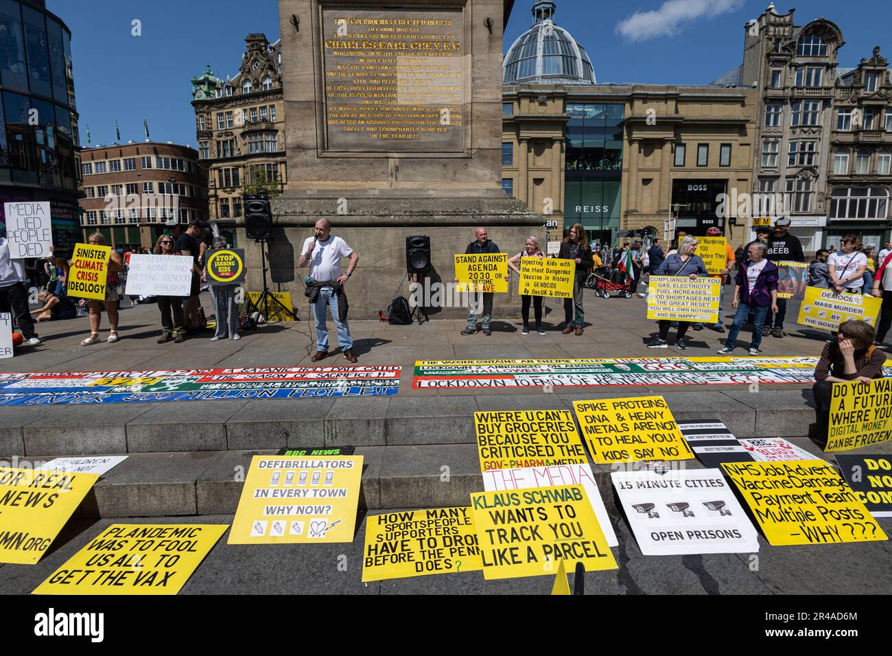 A diverse crowd of people gathered in a city setting, each holding ...