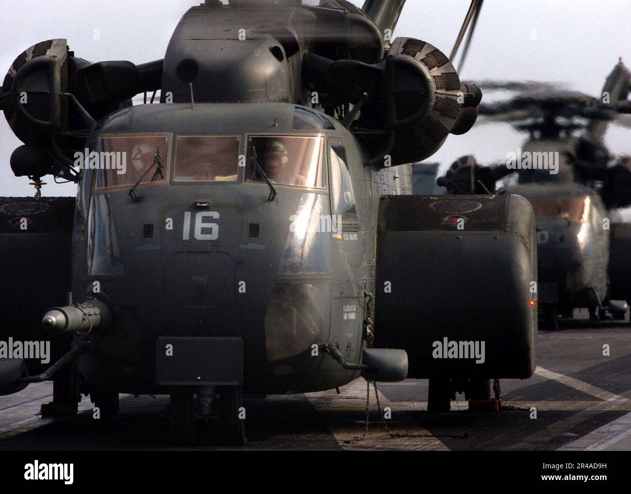 US Navy Two MH-53E Sea Dragons sit turning on the flight deck aboard ...