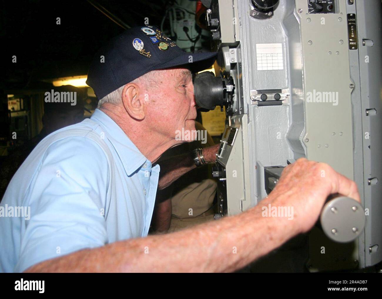 US Navy Pearl Harbor survivor, Woody Derby, takes a look through the ...