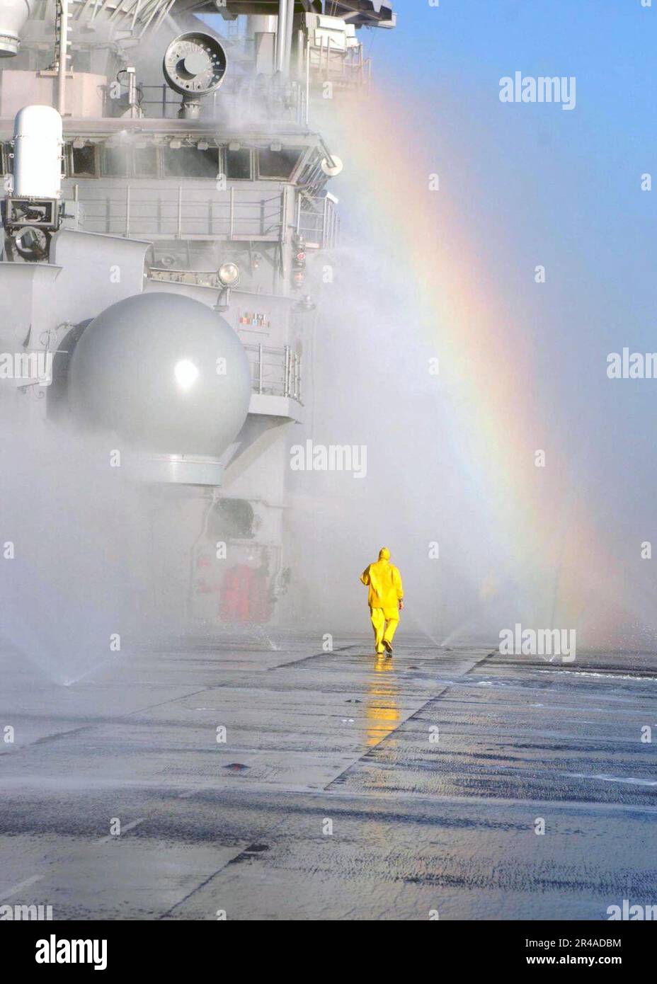 US Navy A rainbow forms as a Sailor makes a final check of the ...
