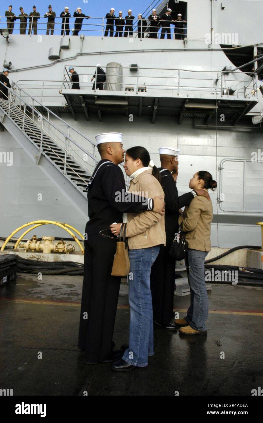 US Navy Sailors say goodbye before boarding the amphibious transport ...