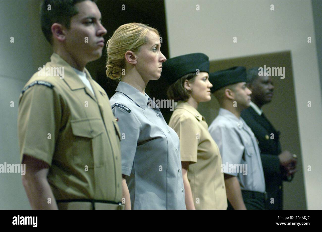 US Navy Four Navy Sailors stand at attention as they model the khaki ...