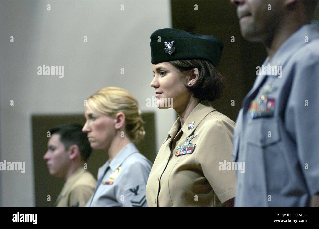 US Navy Four Navy Sailors stand at attention as they model the khaki ...