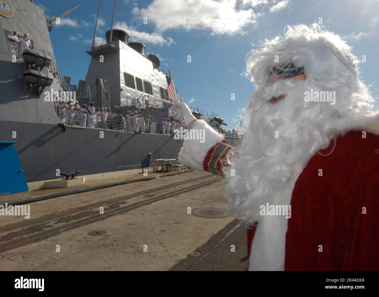 US Navy A family member dressed in a Santa Claus costume waves an ...