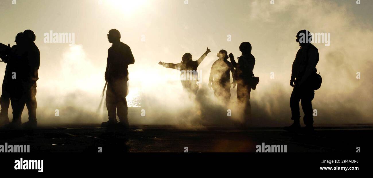 US Navy A catapult crew clears the shot line prior to launching another ...