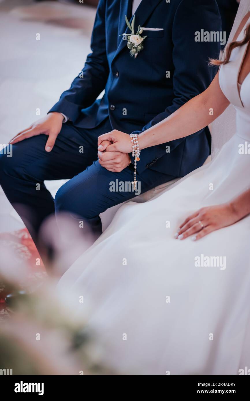 The bride and the groom in a church during their wedding ceremony Stock ...