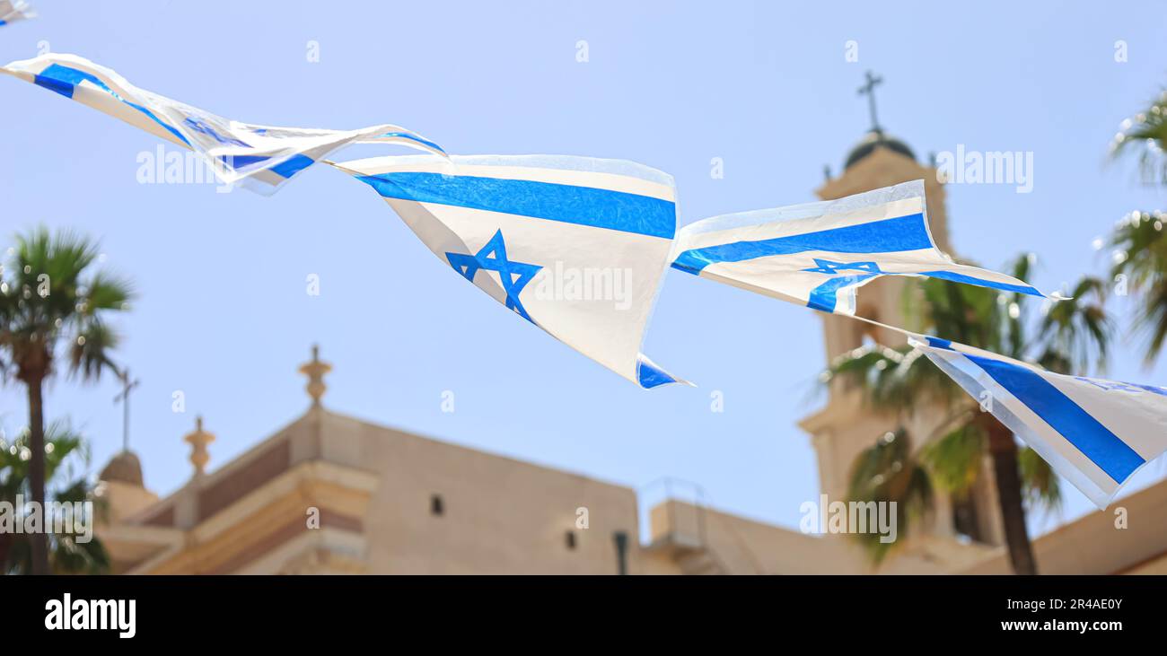 Hanging flags of Israel on city street Stock Photo - Alamy