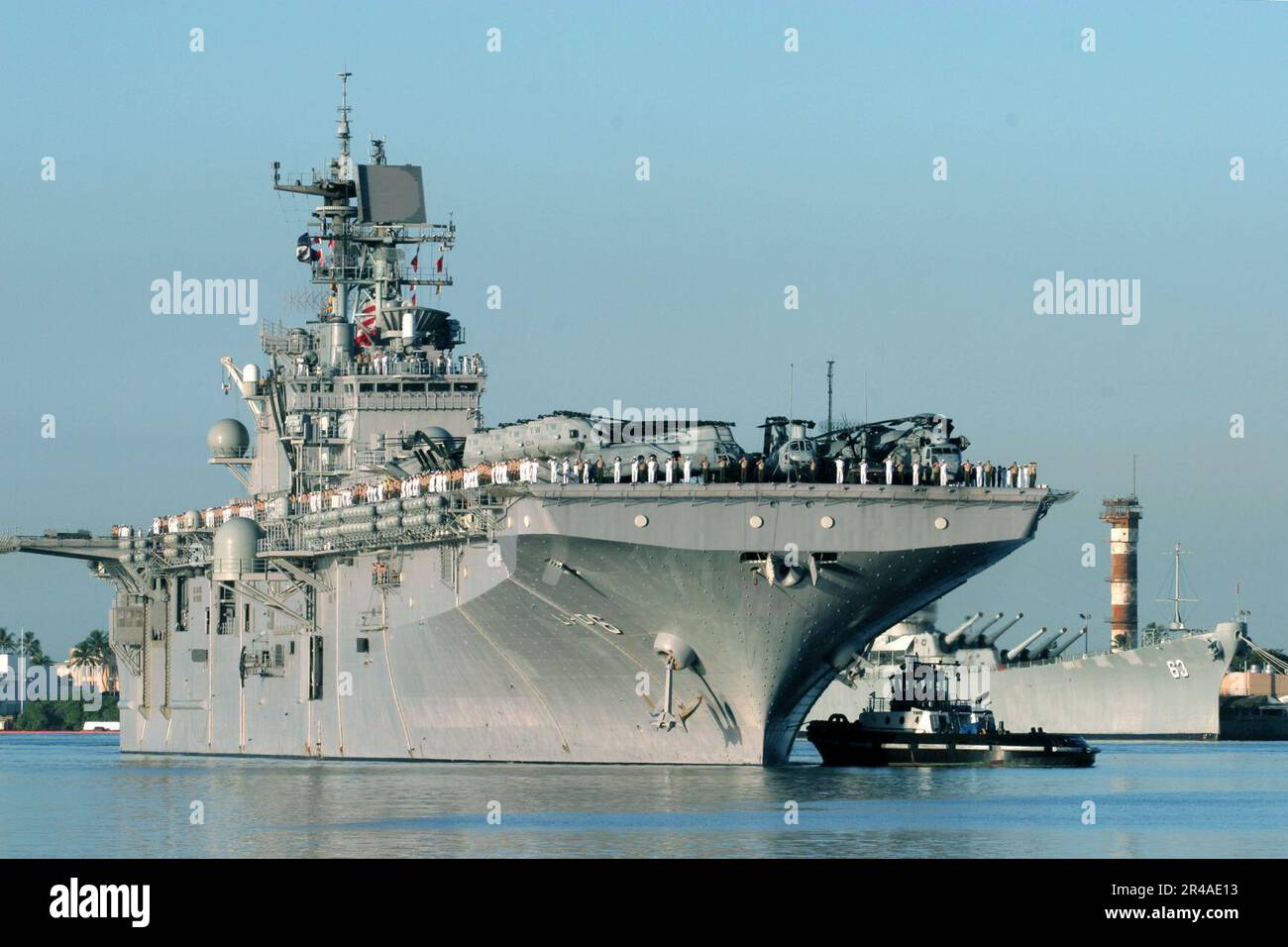 US Navy Sailors and Marines man the rails aboard the amphibious assault ...
