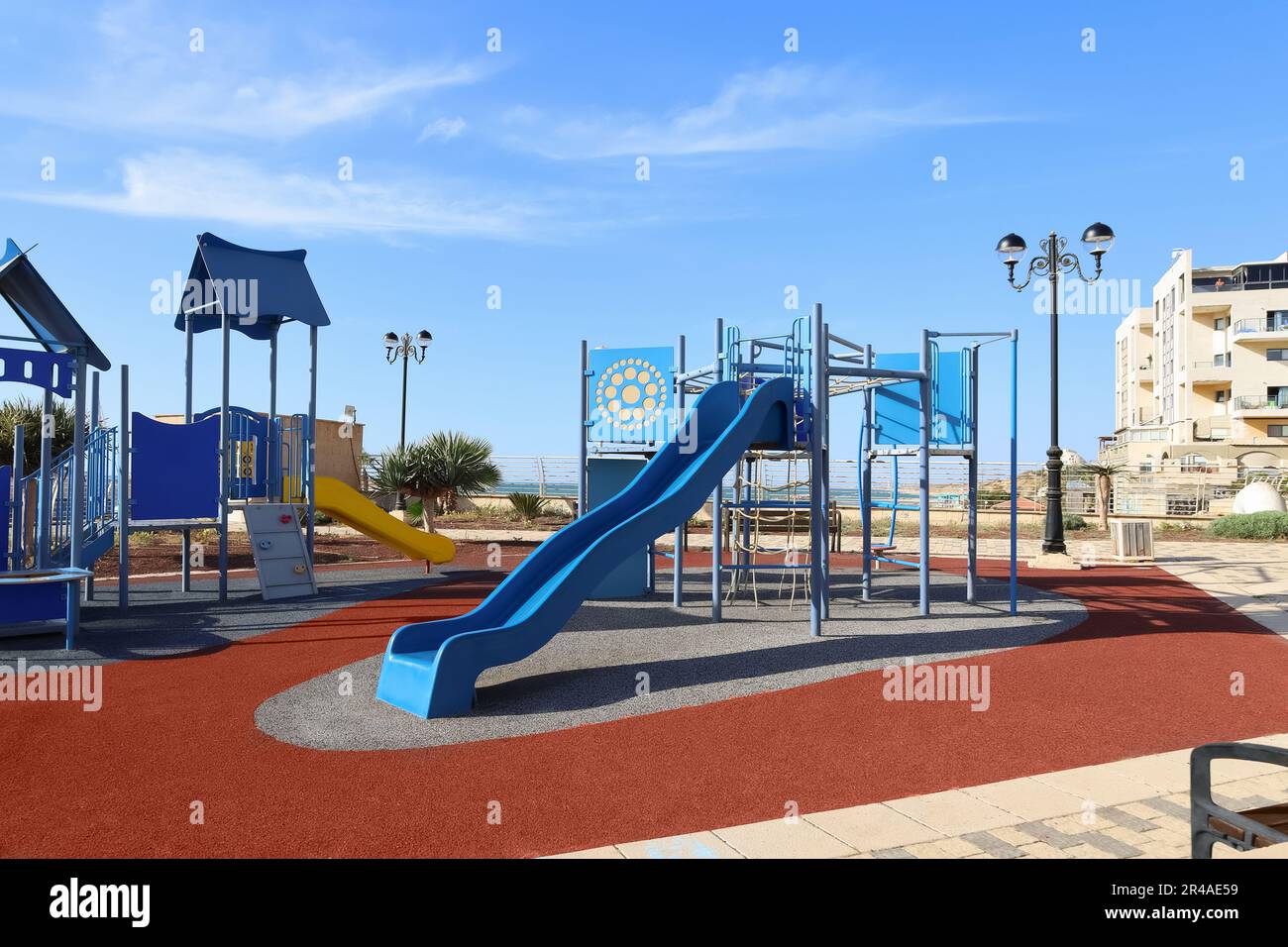 View of children's playground with slide at sea resort Stock Photo - Alamy