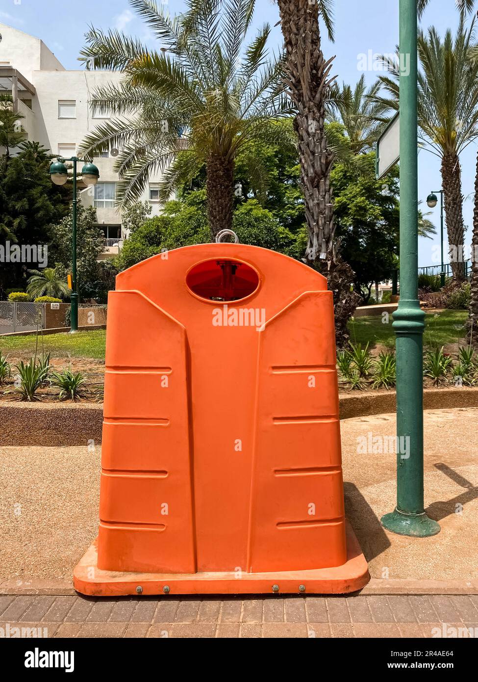 Orange garbage container on city street Stock Photo - Alamy