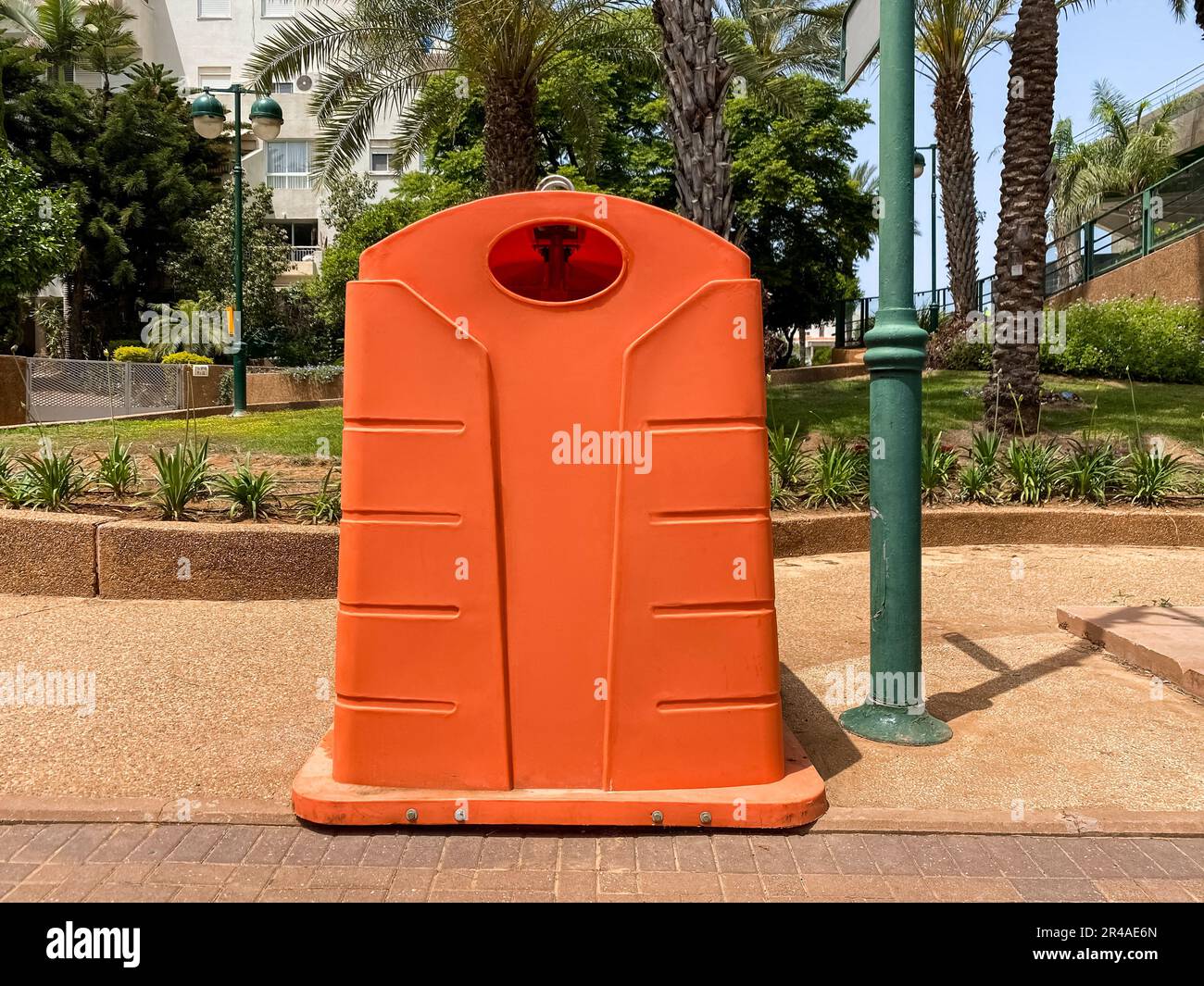 Orange garbage container on city street Stock Photo - Alamy