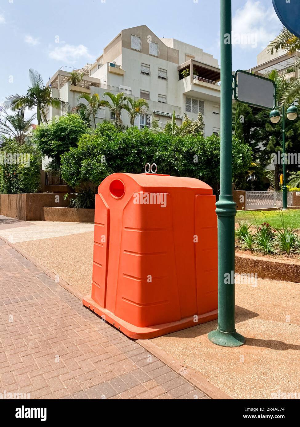 Orange garbage container on city street Stock Photo - Alamy