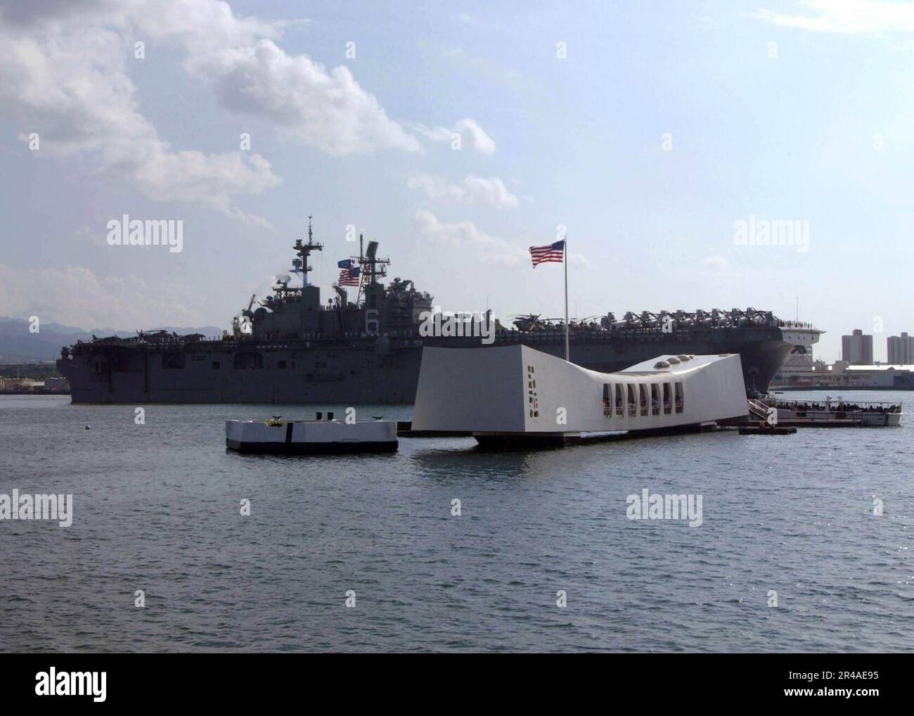 US Navy Sailors and Marines man the rails aboard the amphibious assault ...