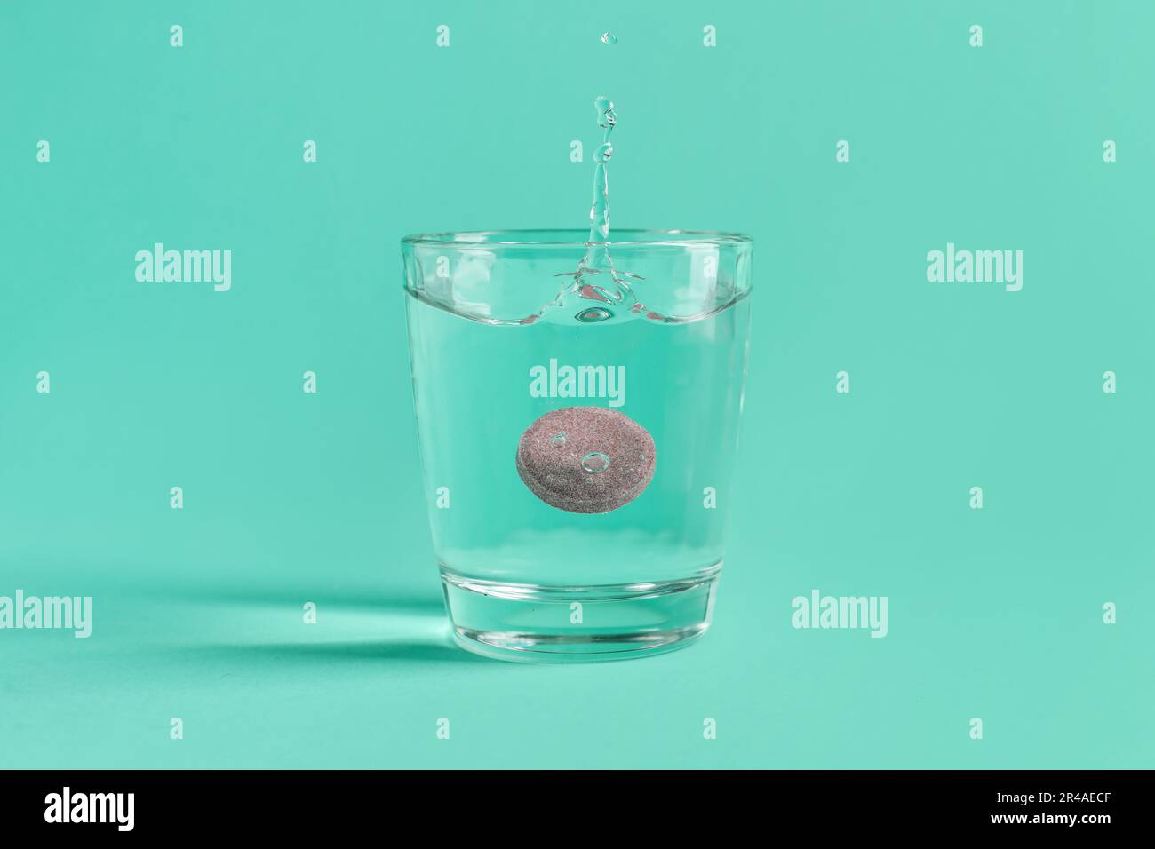 Glass of water with soluble tablet on turquoise background Stock Photo ...